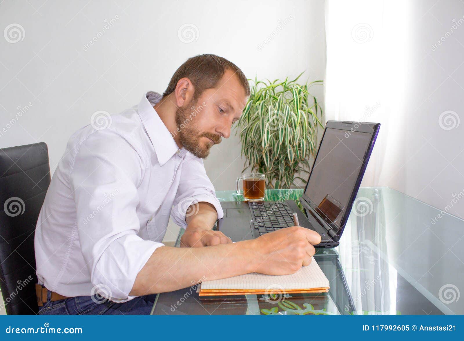 Man behind laptop at work stock image. Image of looking - 117992605