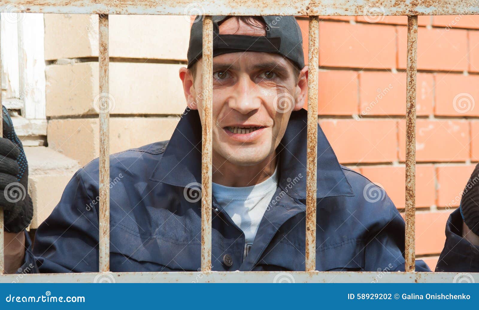 Man behind metallic bars stock photo. Image of captivity - 58929202