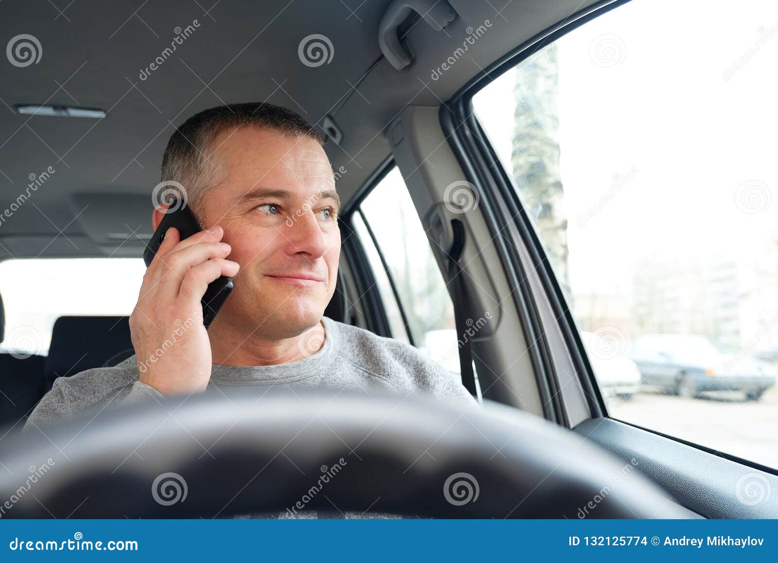 The Man Behind the Wheel Sitting in the Car. Takes a Phone Call. Stock ...