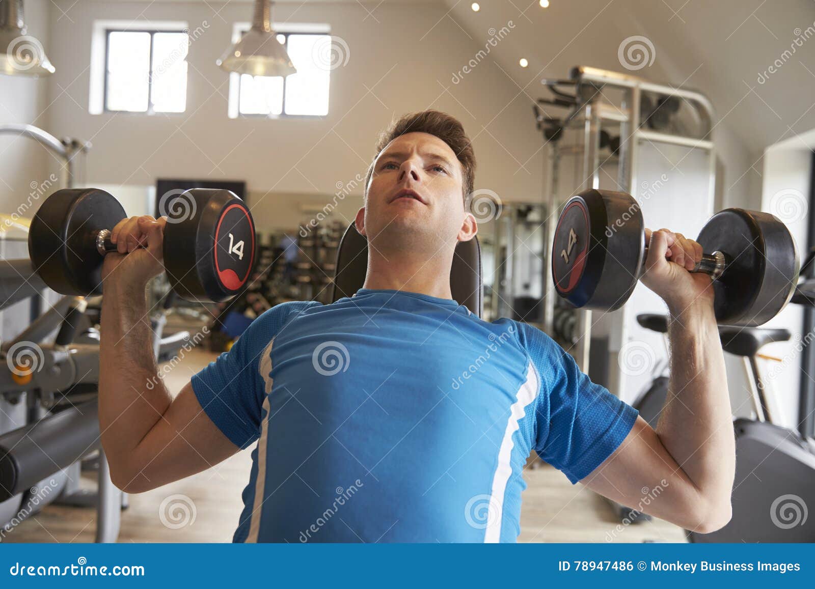 Man Bench Pressing Dumbbells at a Gym, Close Up Stock Photo - Image of ...