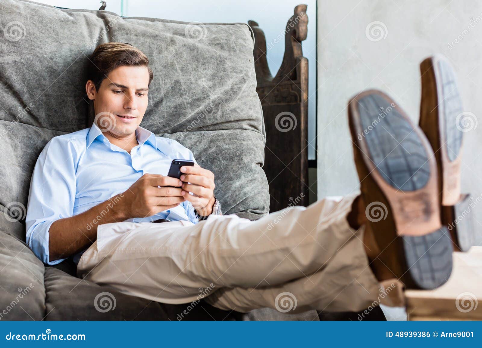Man in Big Chair Texting with Phone Stock Photo - Image of caucasian ...