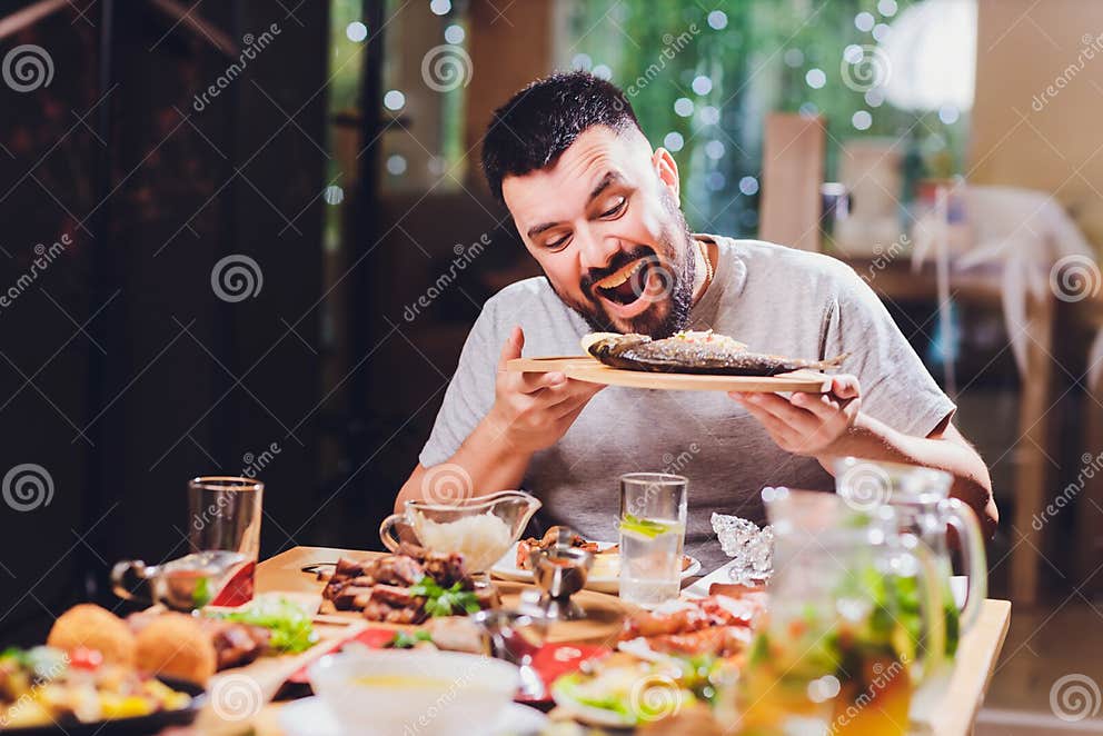 Man at the Big Table with Food. Stock Photo - Image of face, family ...