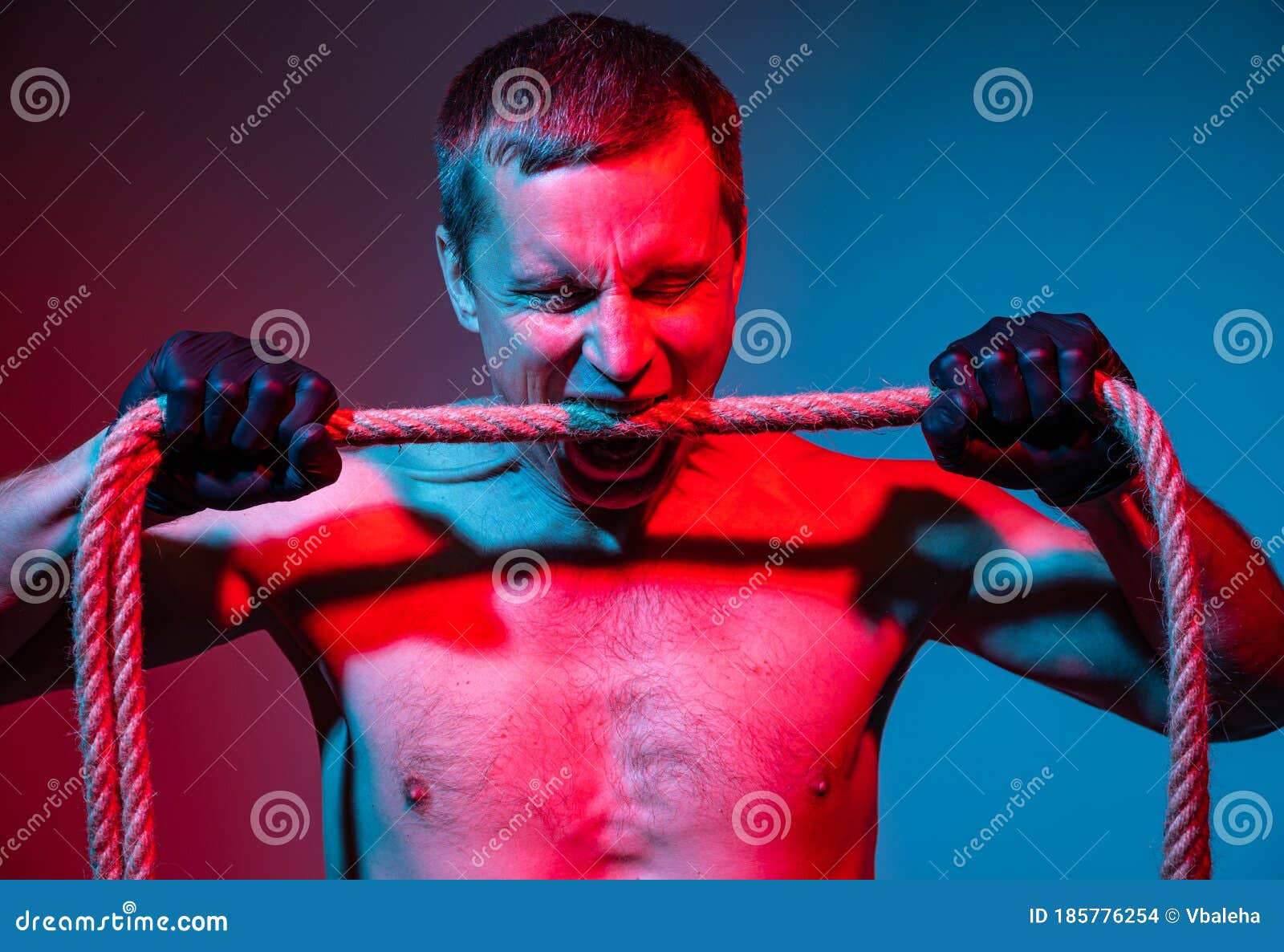 Man bites a rope stock photo. Image of bite, model, gymnastics - 185776254
