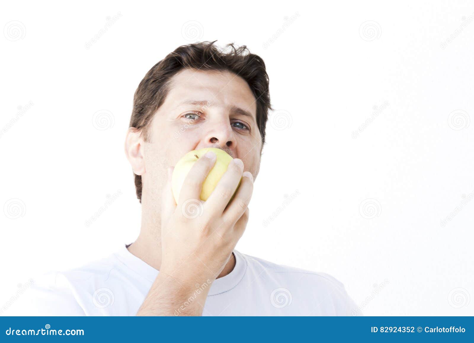 Man is biting an apple stock photo. Image of student - 82924352