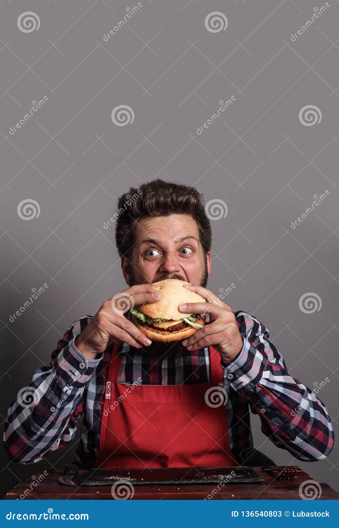 Man biting black hamburger stock image. Image of homemade - 136540803