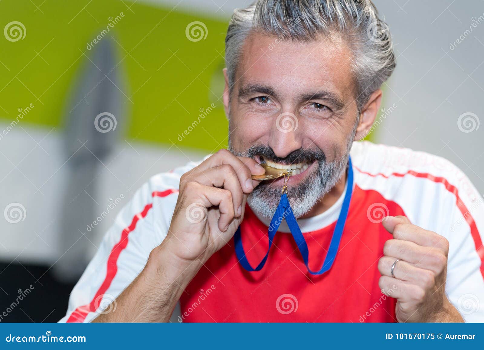 Man biting gold medal stock image. Image of silver, color - 101670175