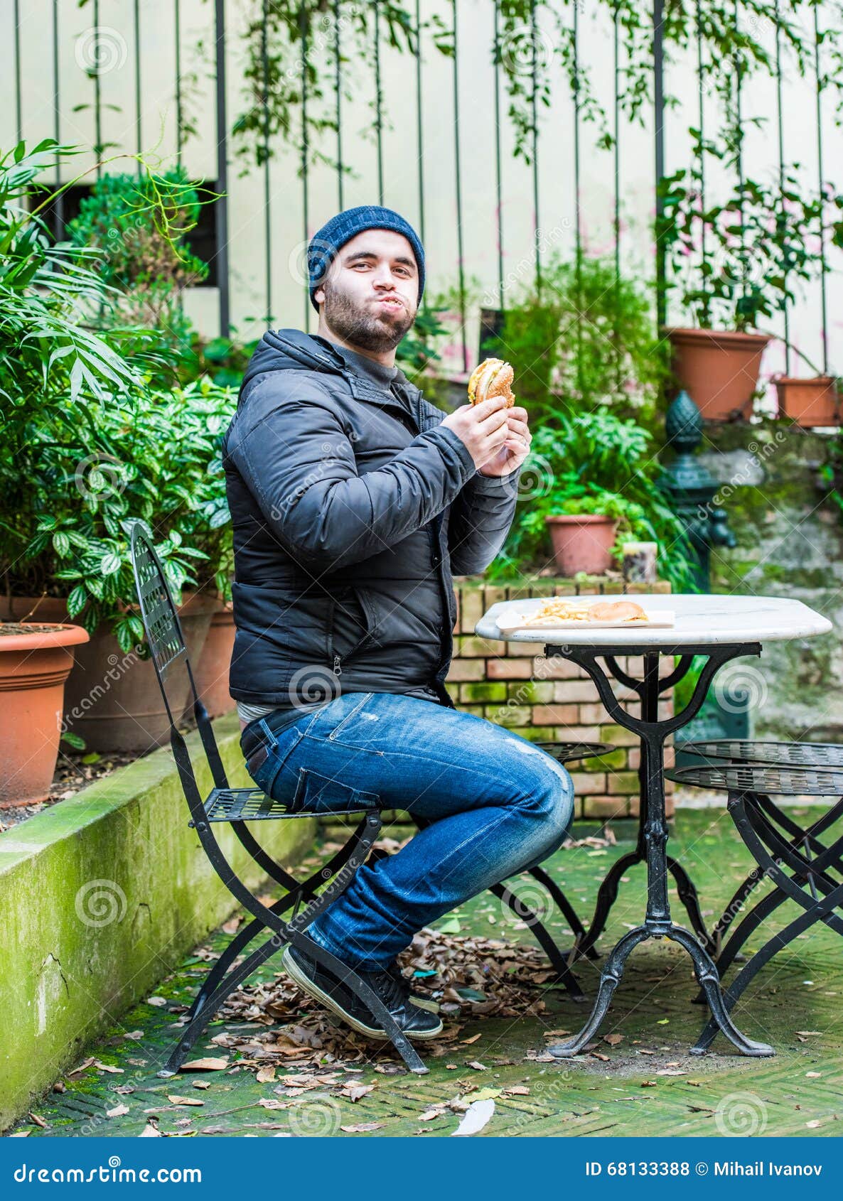 Man Biting a Hamburger and Making a Funny Face Stock Photo - Image of ...