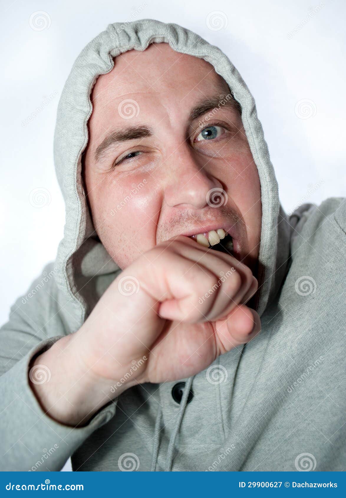 Amused Young Man Biting His Fist Stock Image - Image of fist ...