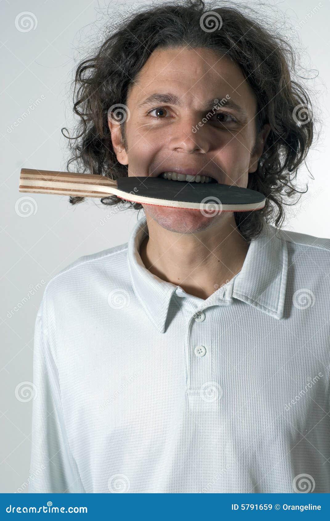 Man Biting Ping Pong Paddle - Vertical Picture. Image: 5791659