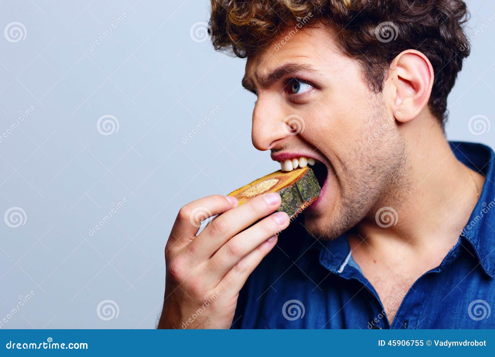 Man biting wood circles stock image. Image of beautiful - 45906755