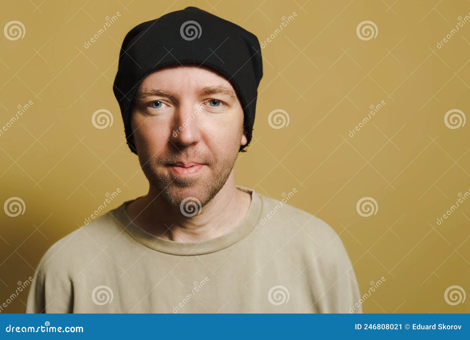 The Man in the Black Cap Looks Ironically. Portrait of a Young Man ...