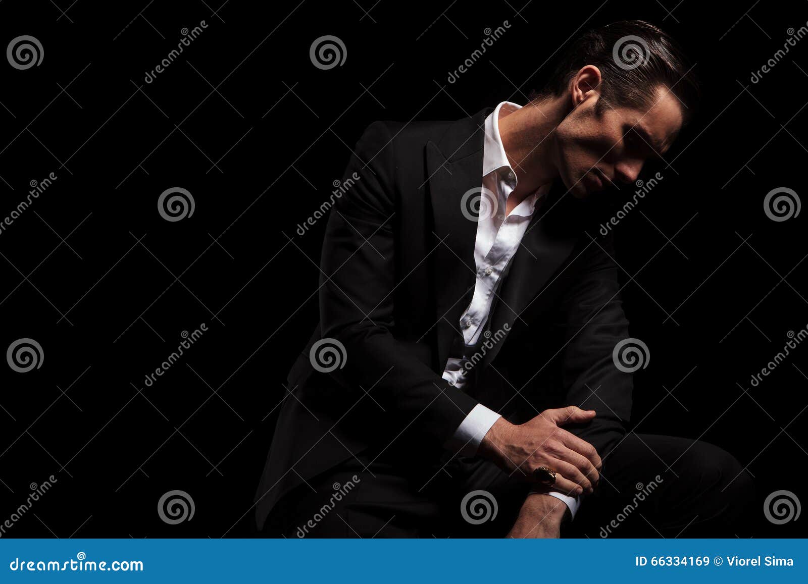 Man in Black in Dark Studio Looking Down Stock Image - Image of black ...