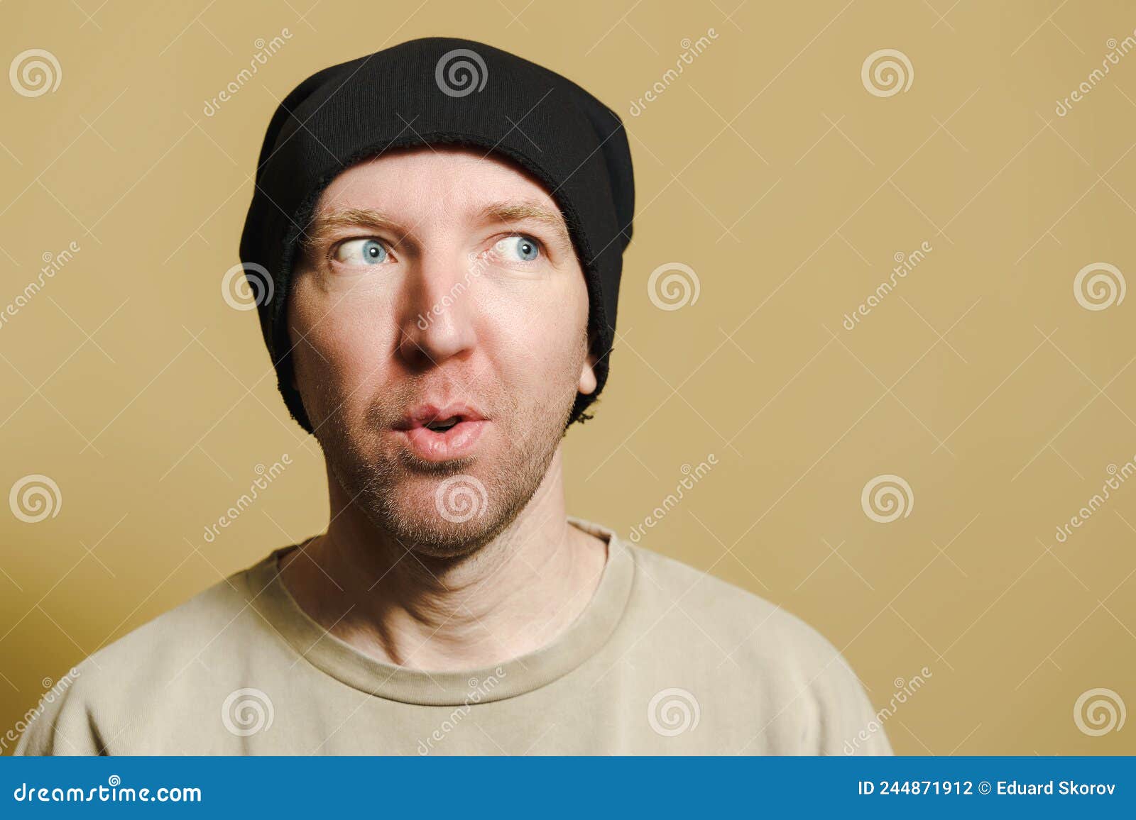 A Man in a Black Hat Looks with Hope. Portrait of a Young Man Making ...
