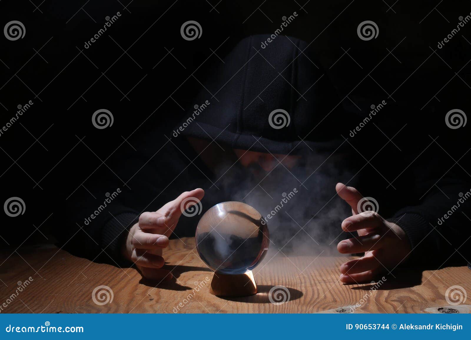 Man in a Black Hood with Cristal Ball Stock Photo - Image of glass ...