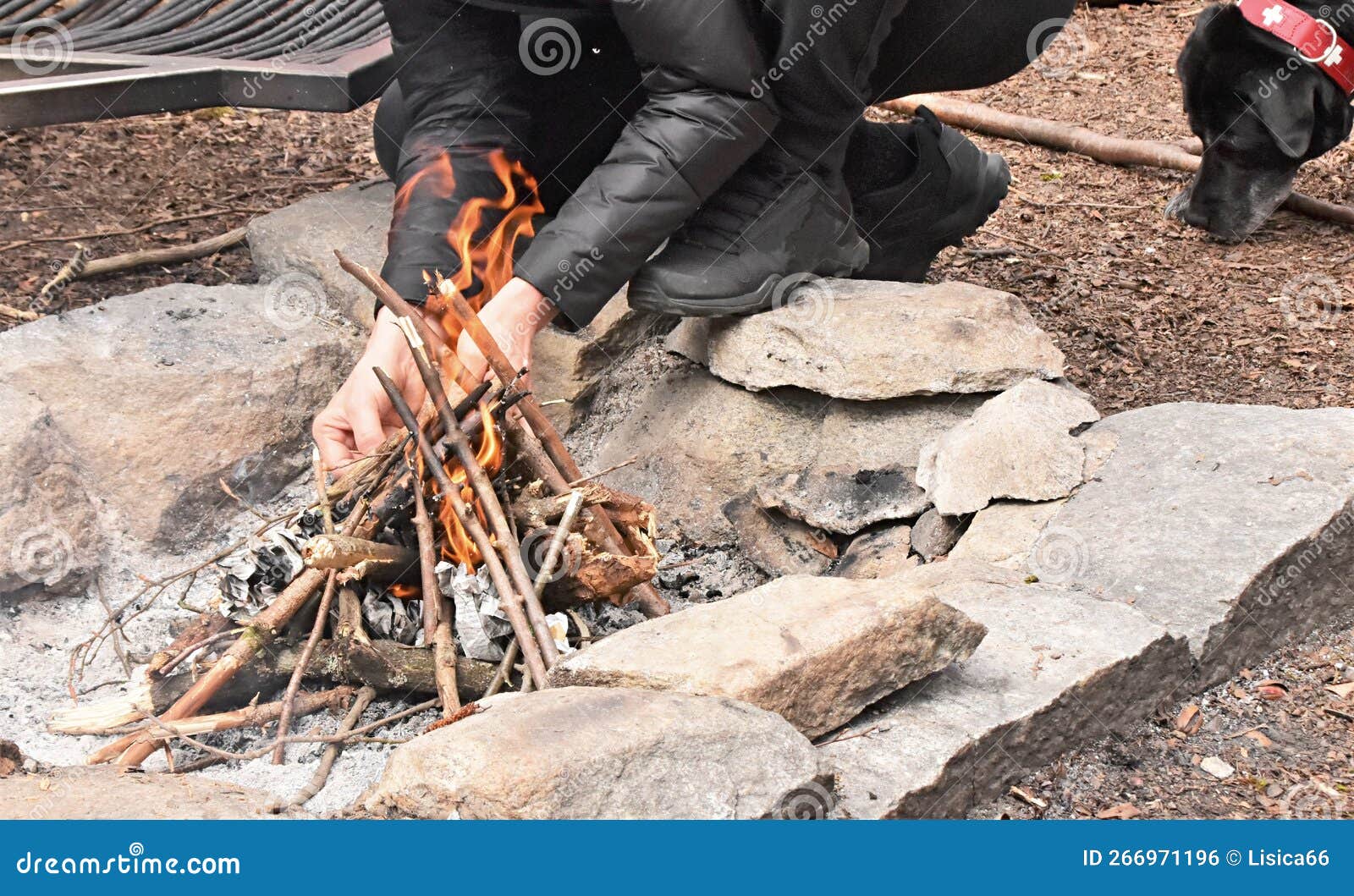 Man Lighting a Fire Outdoors Stock Photo - Image of fire, glowing ...