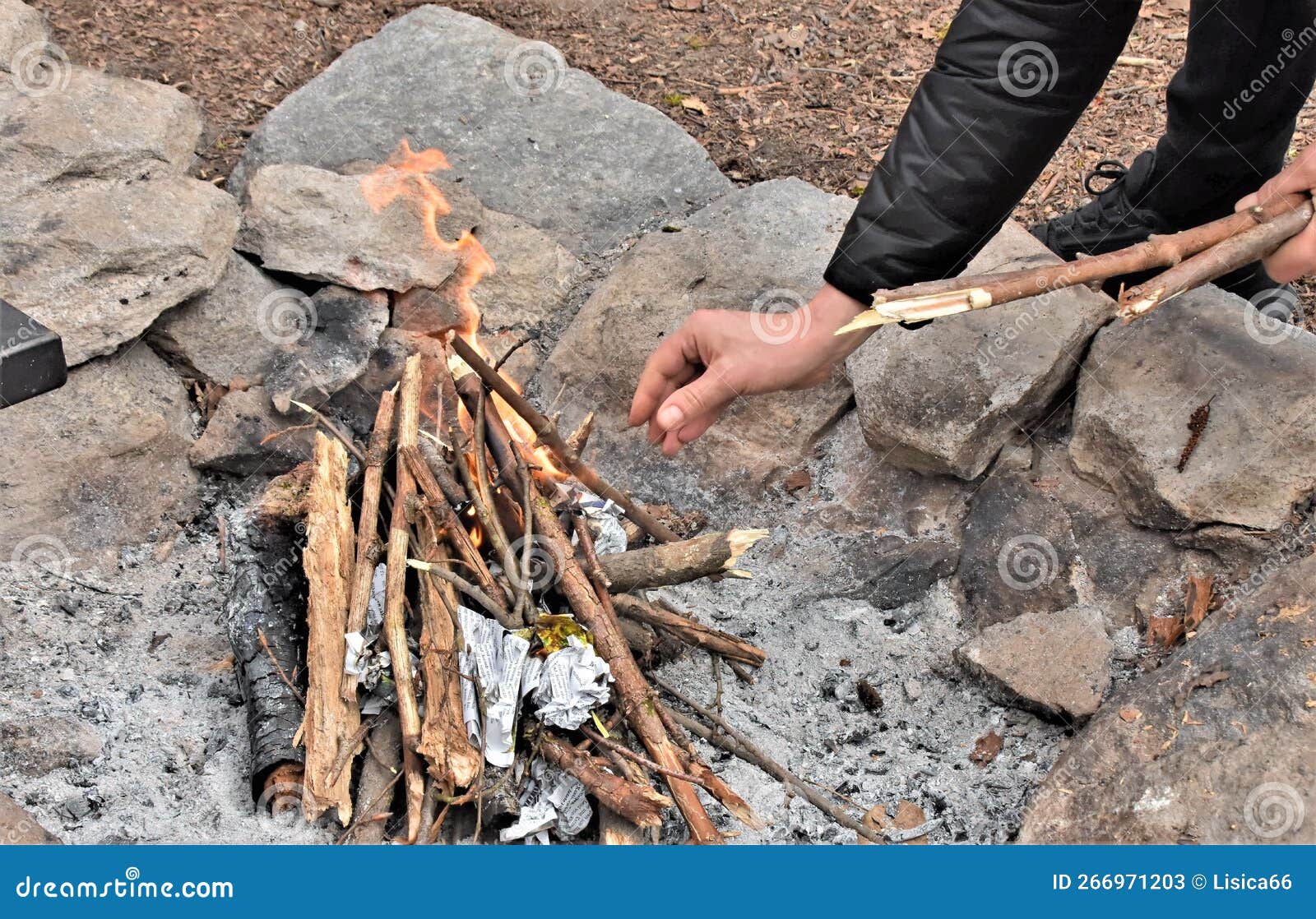 Man Lighting a Fire Outdoors Stock Image - Image of black, folded ...