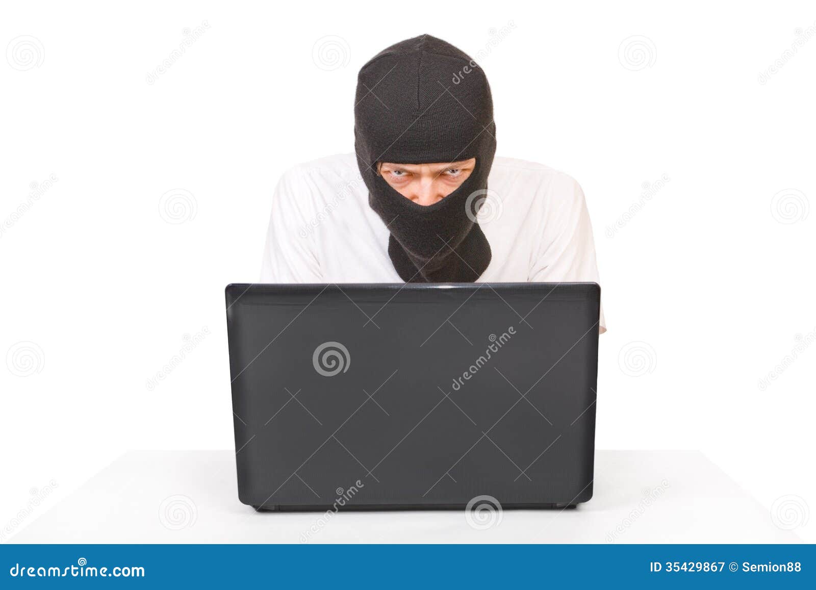 Man in Black Mask with Computer Looking at Camera Stock Image - Image ...