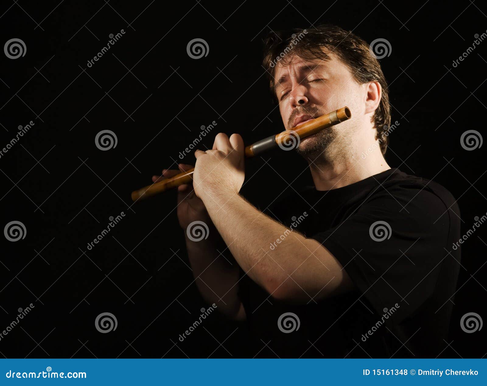 Man in black plays a flute stock photo. Image of player - 15161348
