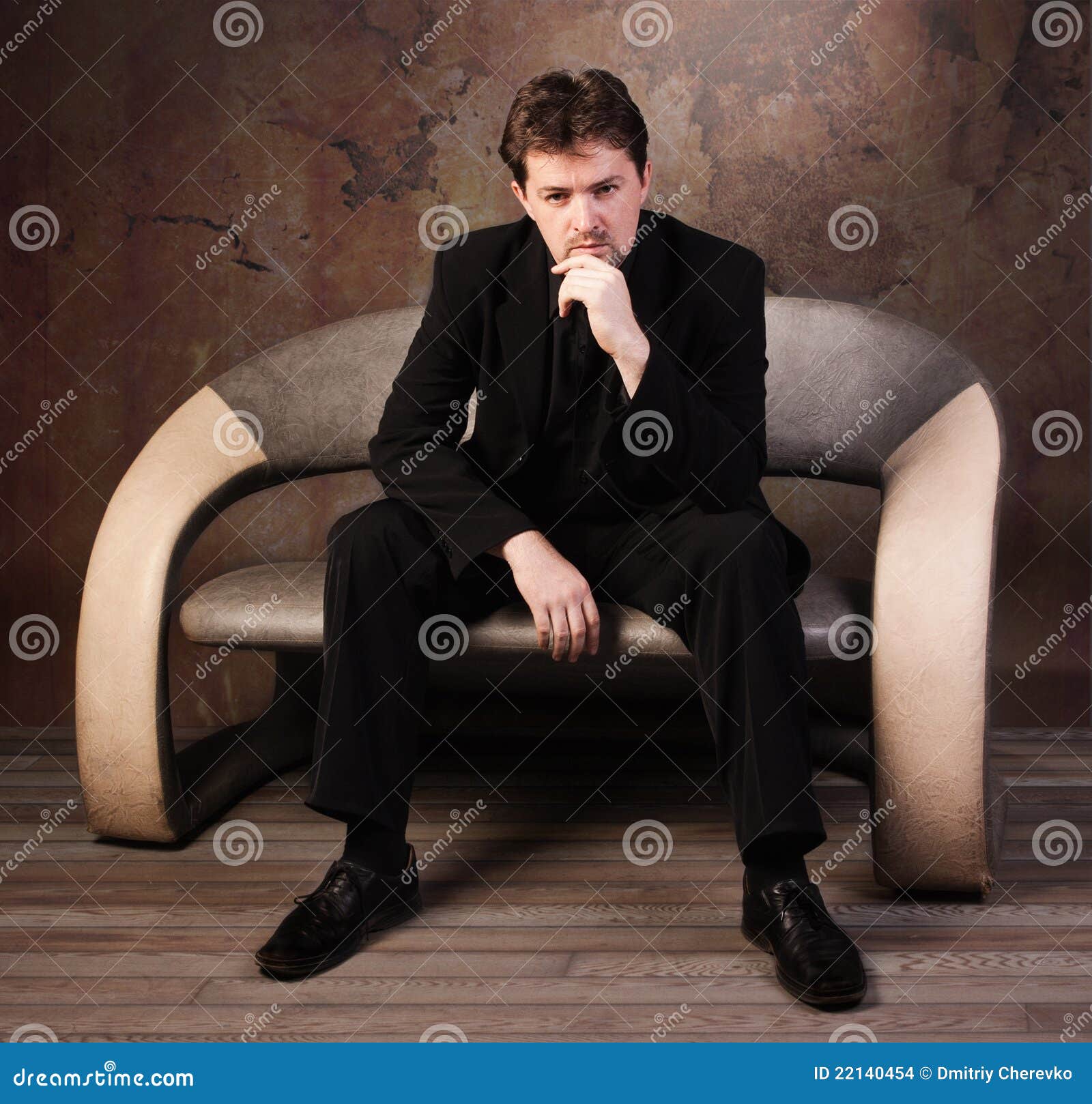 Man in Black Suit Sitting on a Sofa Stock Photo - Image of adult ...