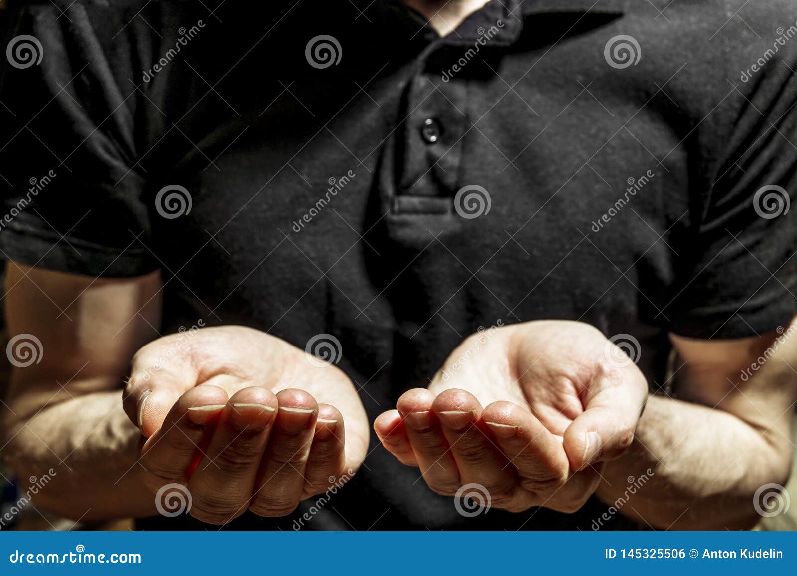 Man in a Black T-shirt Stands with Outstretched Hands Stock Photo ...
