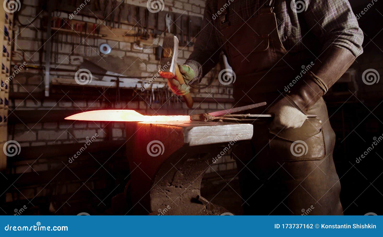 A Man Blacksmith Forging a Knife Blade Using a Hammer Stock Photo ...