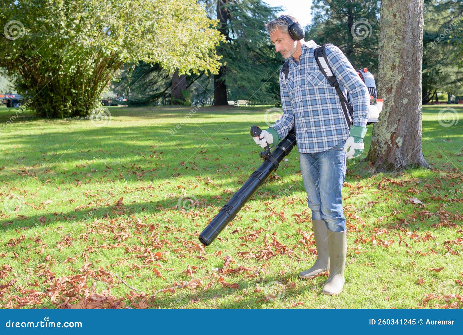 Man blowing leaves stock image. Image of outdoor, worker - 260341245