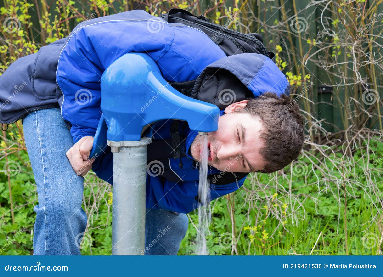 Man in Blue Jacket Drinking Water from Hydrant Pump Stock Photo - Image ...