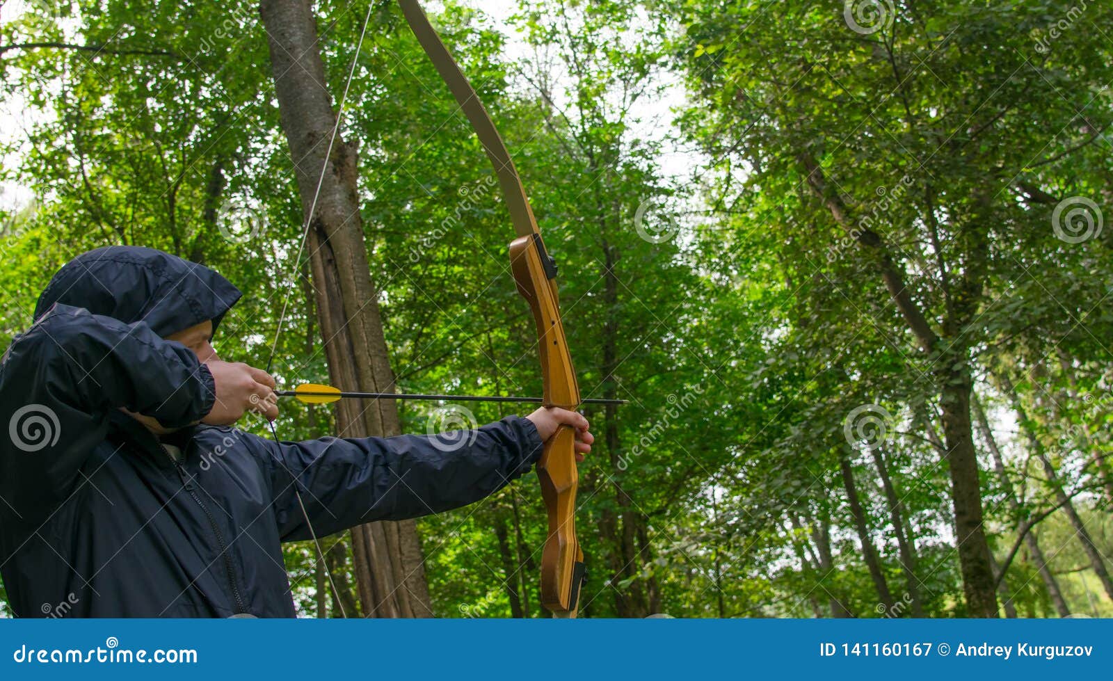 A Man in a Blue Jacket, Pulls the Bowstring, To Hit the Target, Against ...