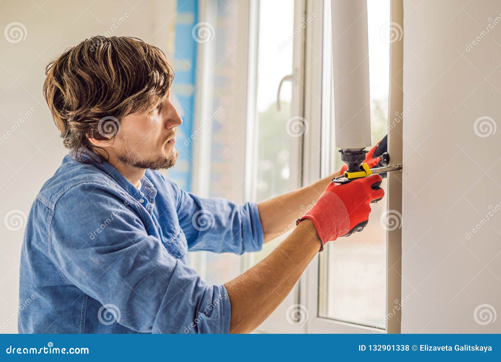 Man in a Blue Shirt Does Window Installation Stock Photo - Image of ...