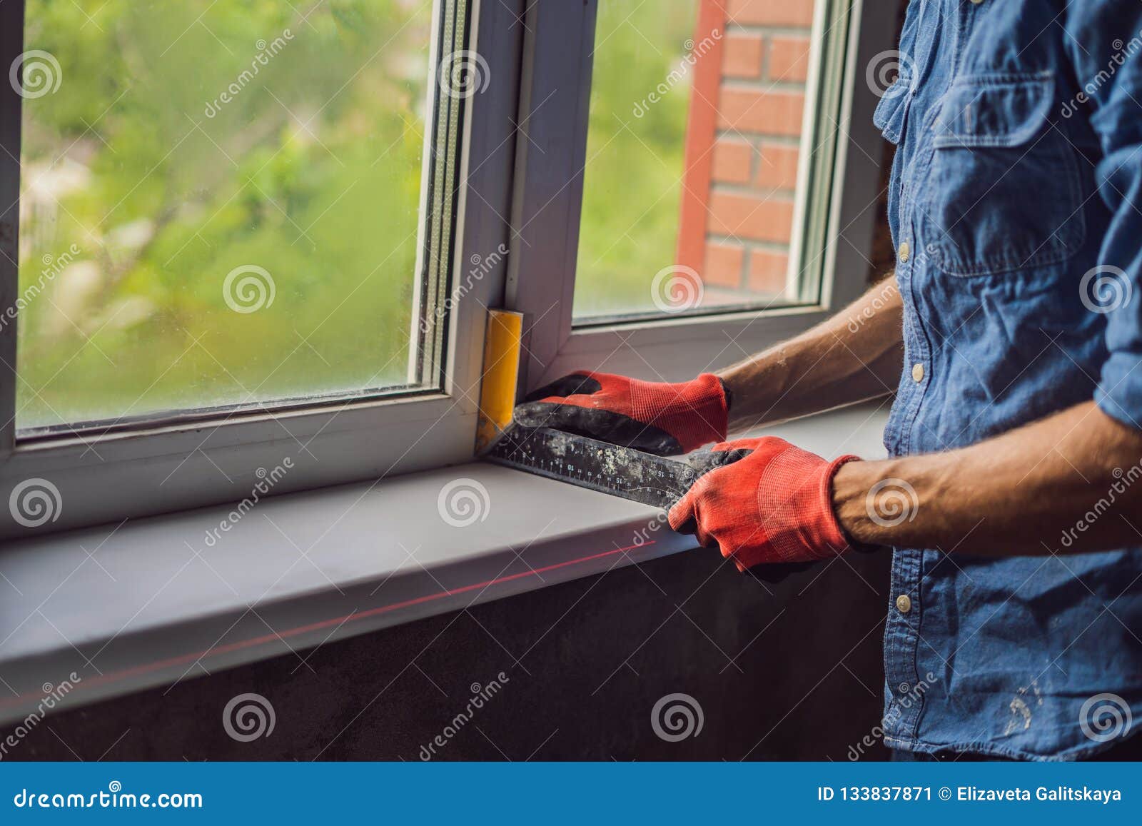 Man in a Blue Shirt Does Window Installation Stock Image - Image of ...