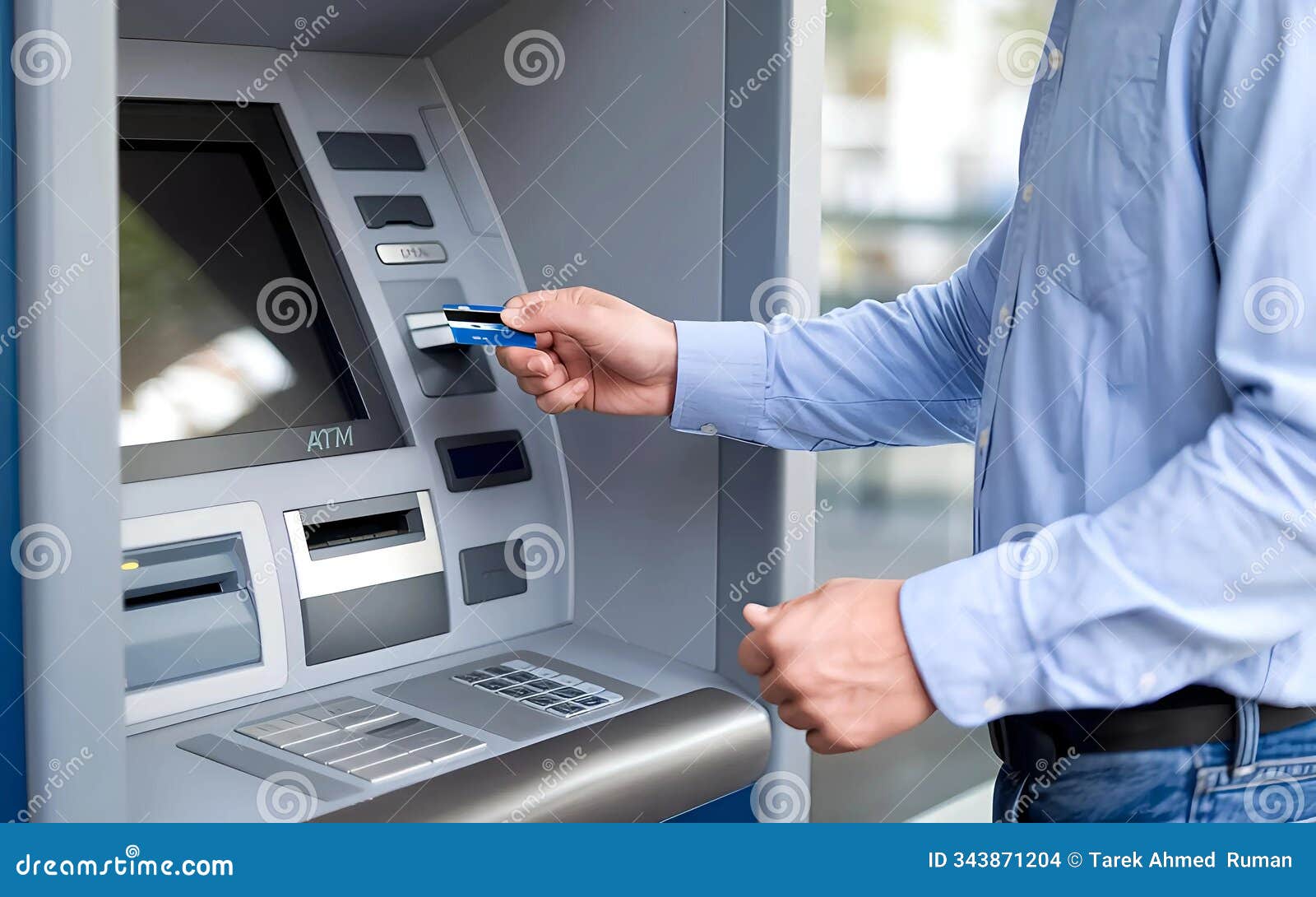A Man in a Blue Shirt Inserts His Debit Card into an ATM Machine. the ...