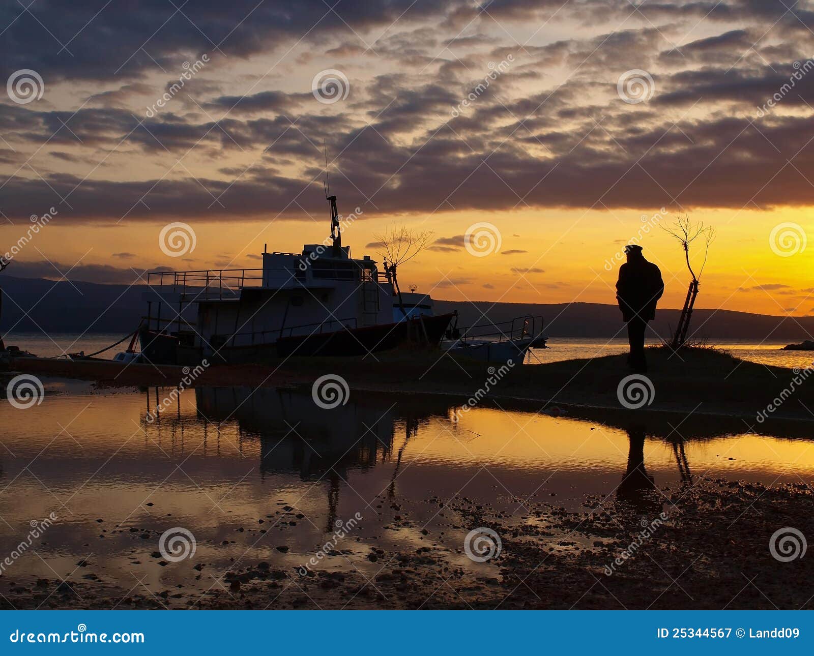 Man and a boats in sunset stock image. Image of life - 25344567
