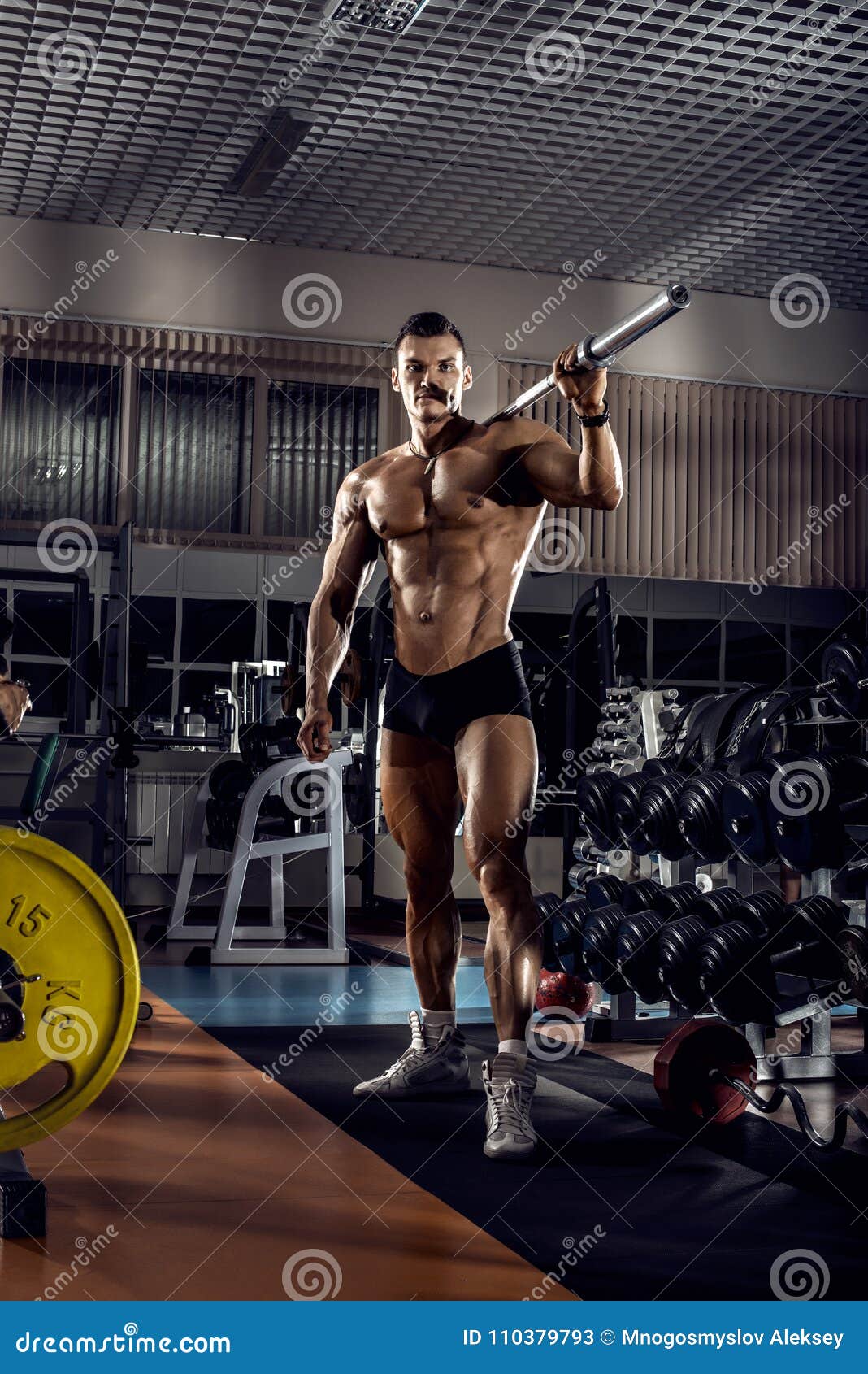 Man bodybuilder in gym stock image. Image of bodybuilding - 110379793