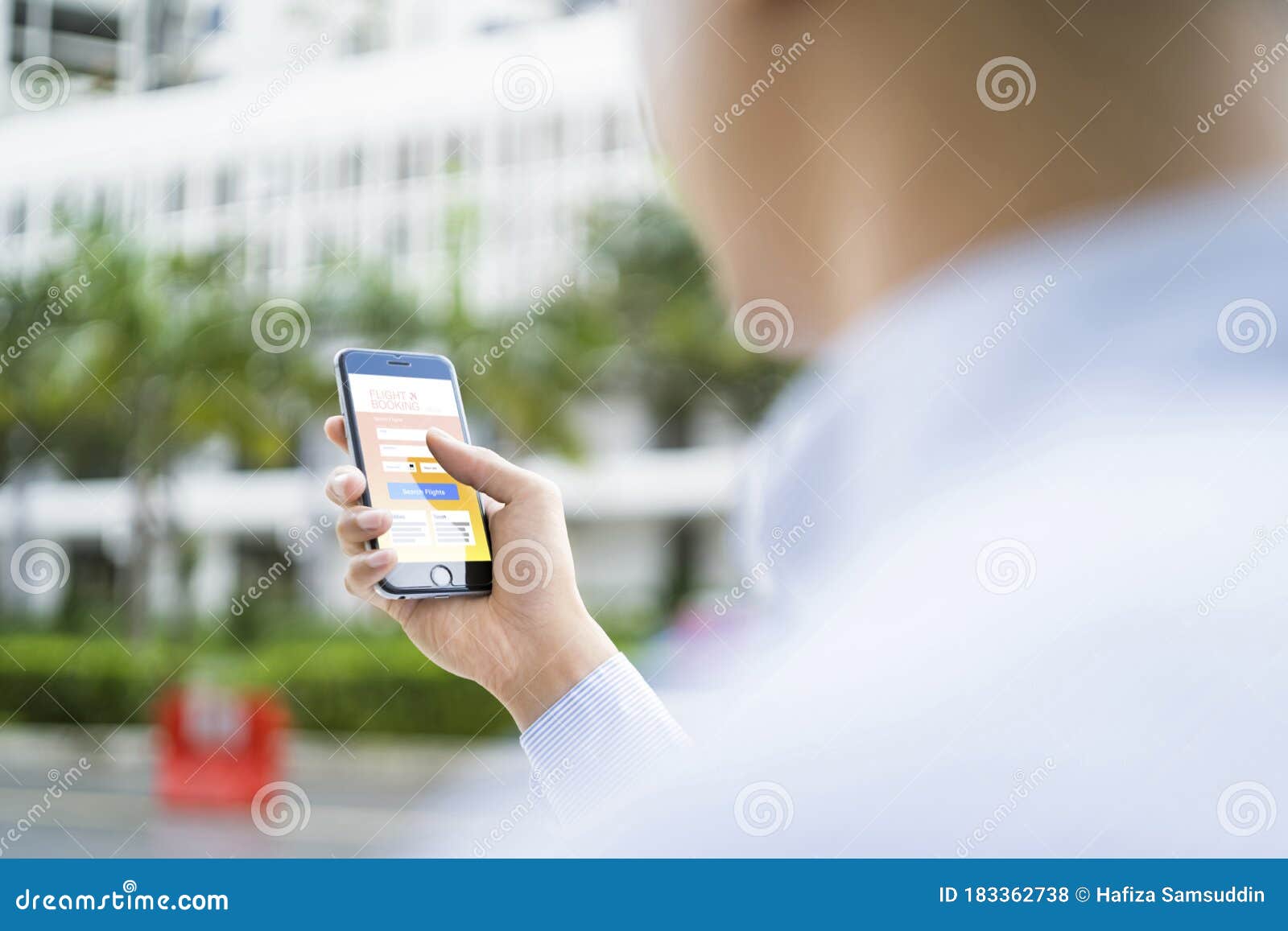 Man Booking for Flight through Application on Mobile Phone Stock Photo ...