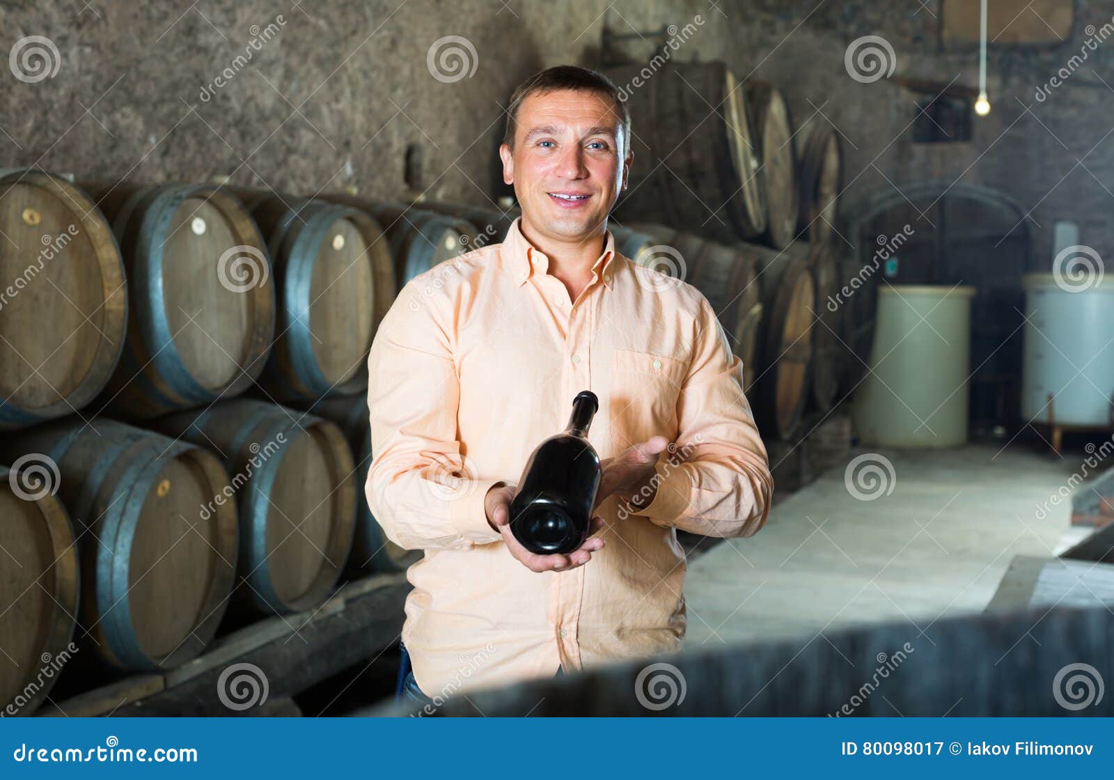 Man with Bottle of Wine in Winery Cellar Stock Image - Image of ...