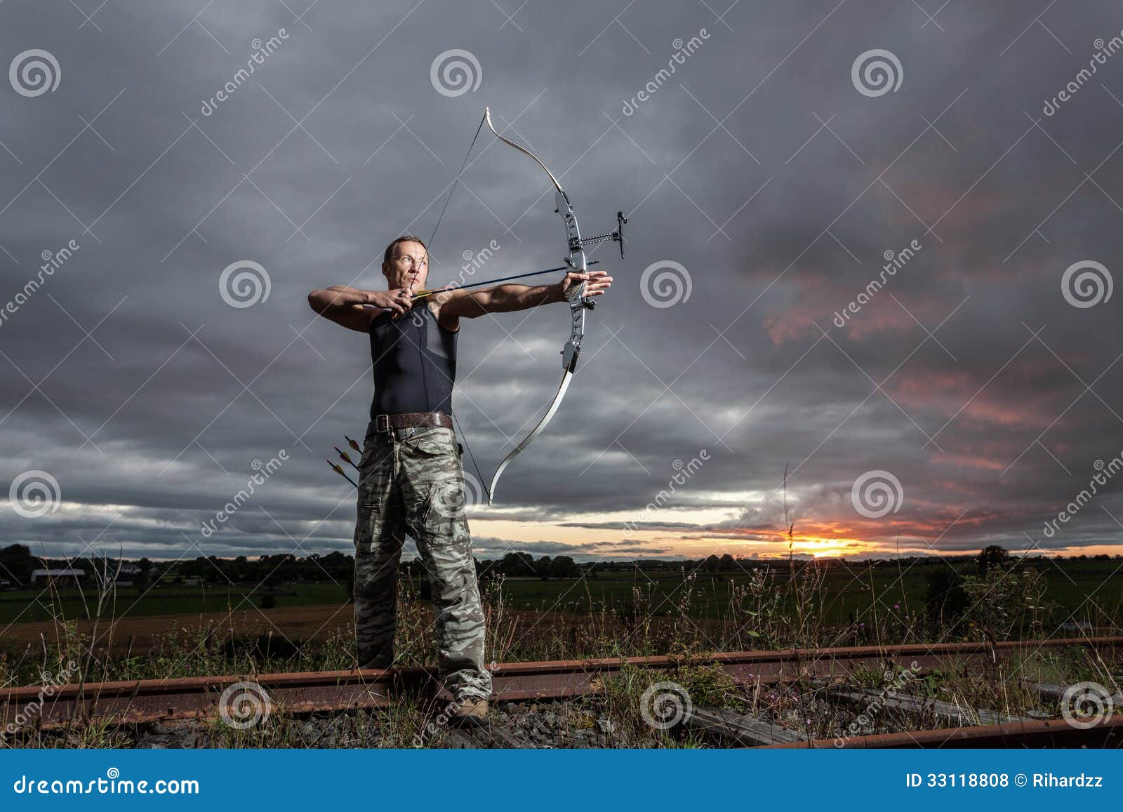 Man with bow and arrows stock photo. Image of rails, grass - 33118808