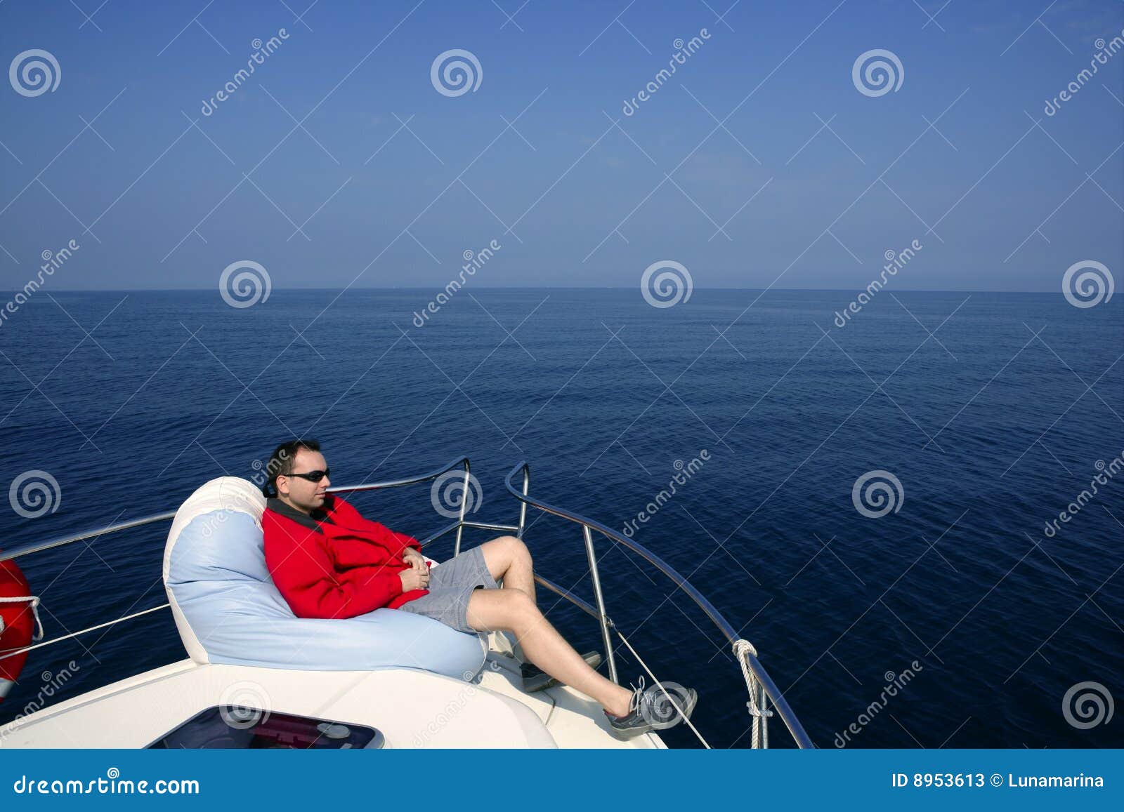 Man on Bow Boat Relaxed on Bean Bag Stock Image - Image of outdoor ...