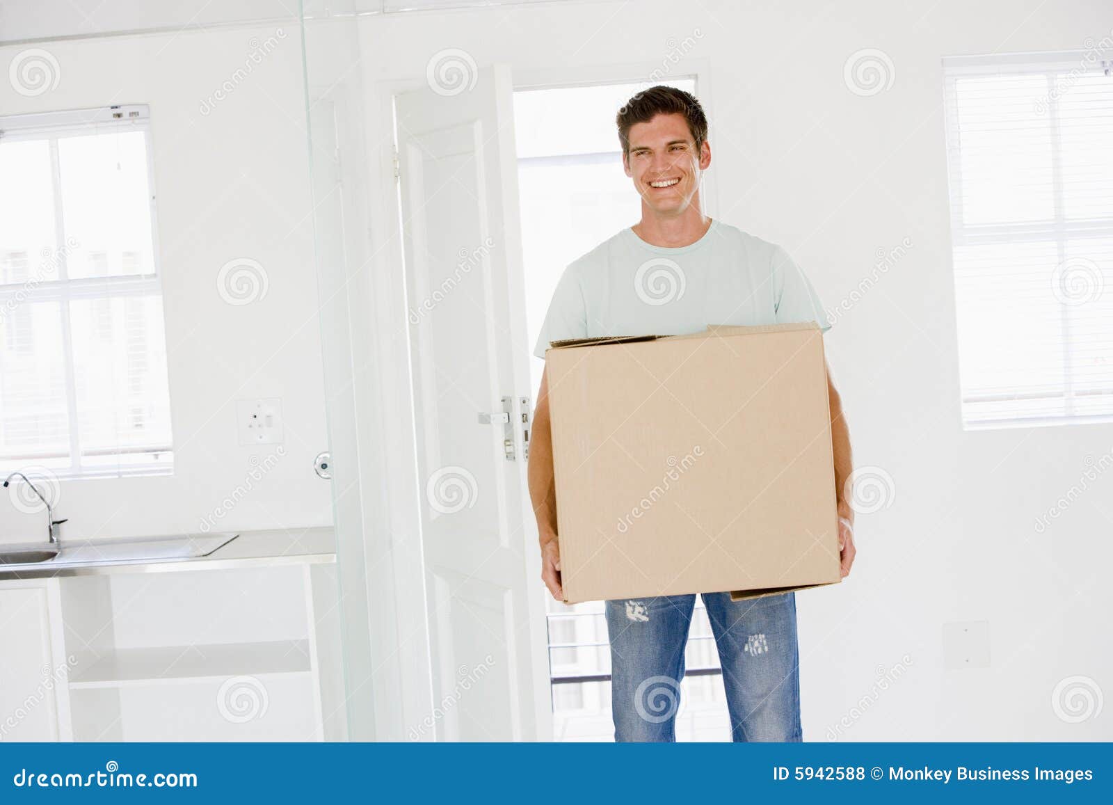 Man with Box Moving into New Home Smiling Stock Photo - Image of happy ...