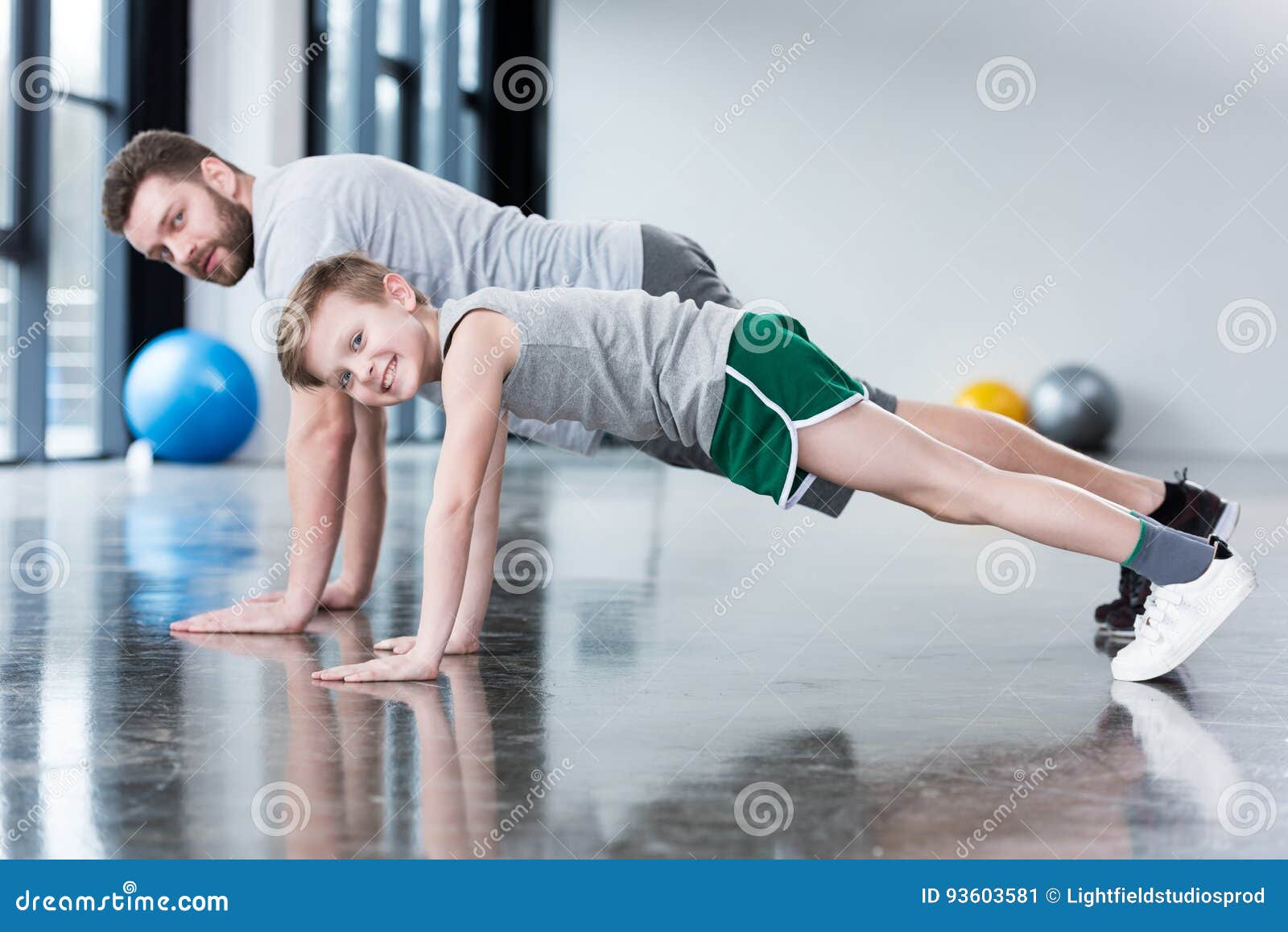 Man and boy doing push ups stock image. Image of exercising - 93603581