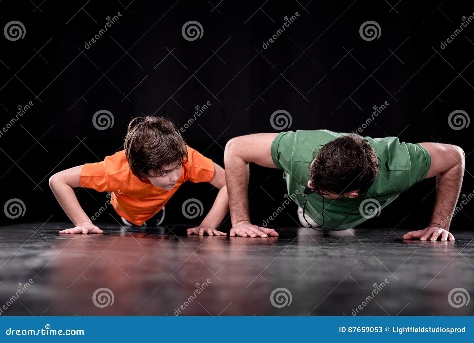 Man and Boy Doing Push Ups Together and Looking at Each Other Stock ...
