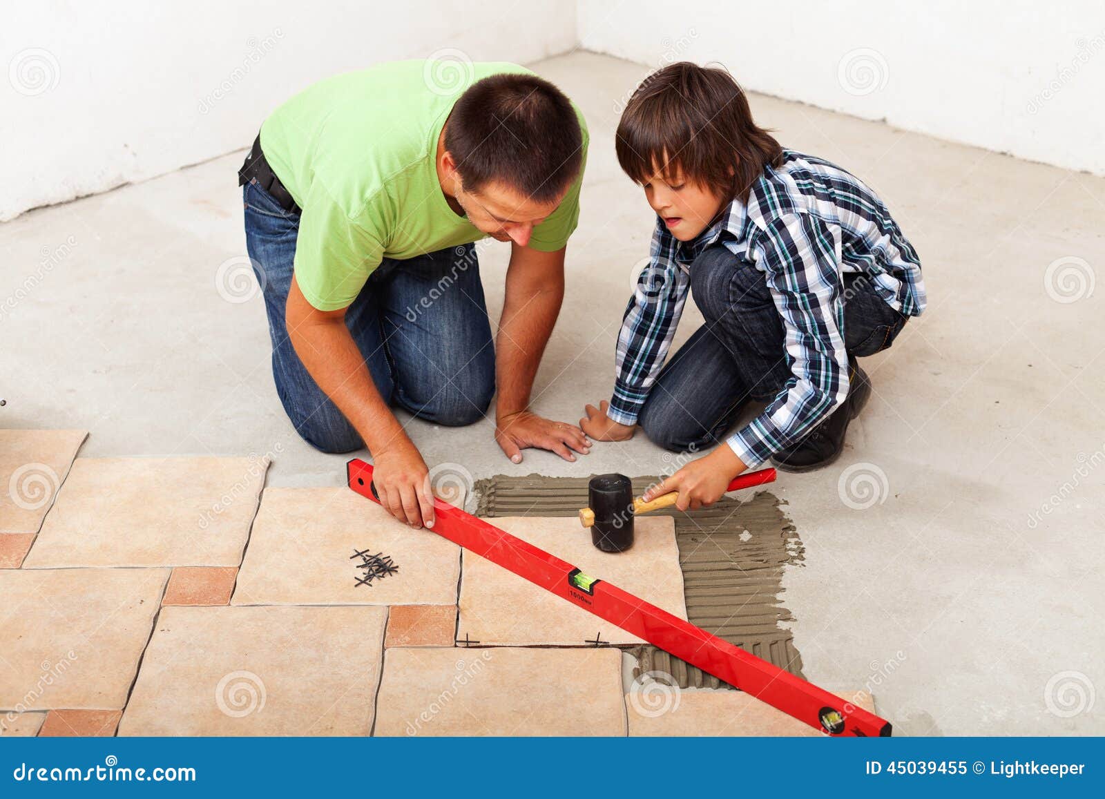 Man and Boy Laying Ceramic Floor Tiles Stock Image - Image of fitting ...