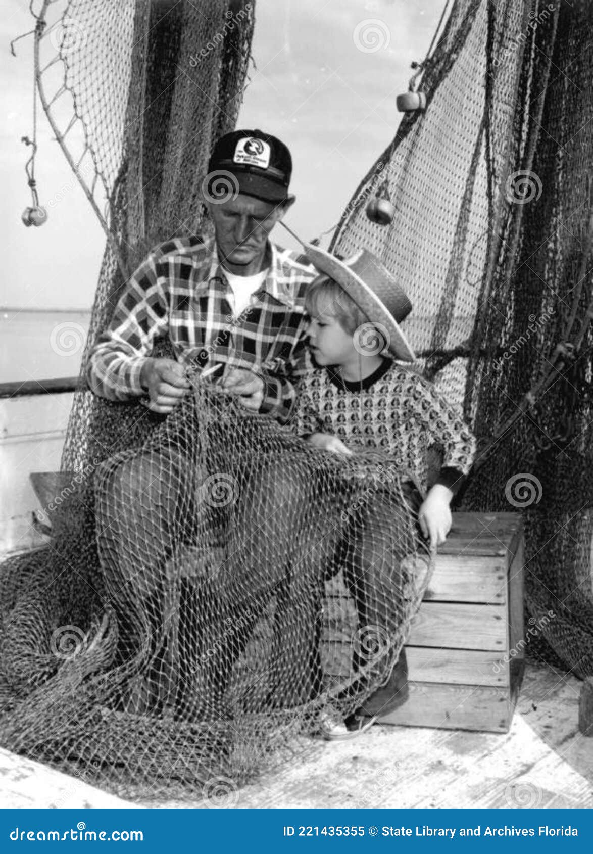Man And Boy Working On Fish Net In A Boat: Apalachicola, Florida ...