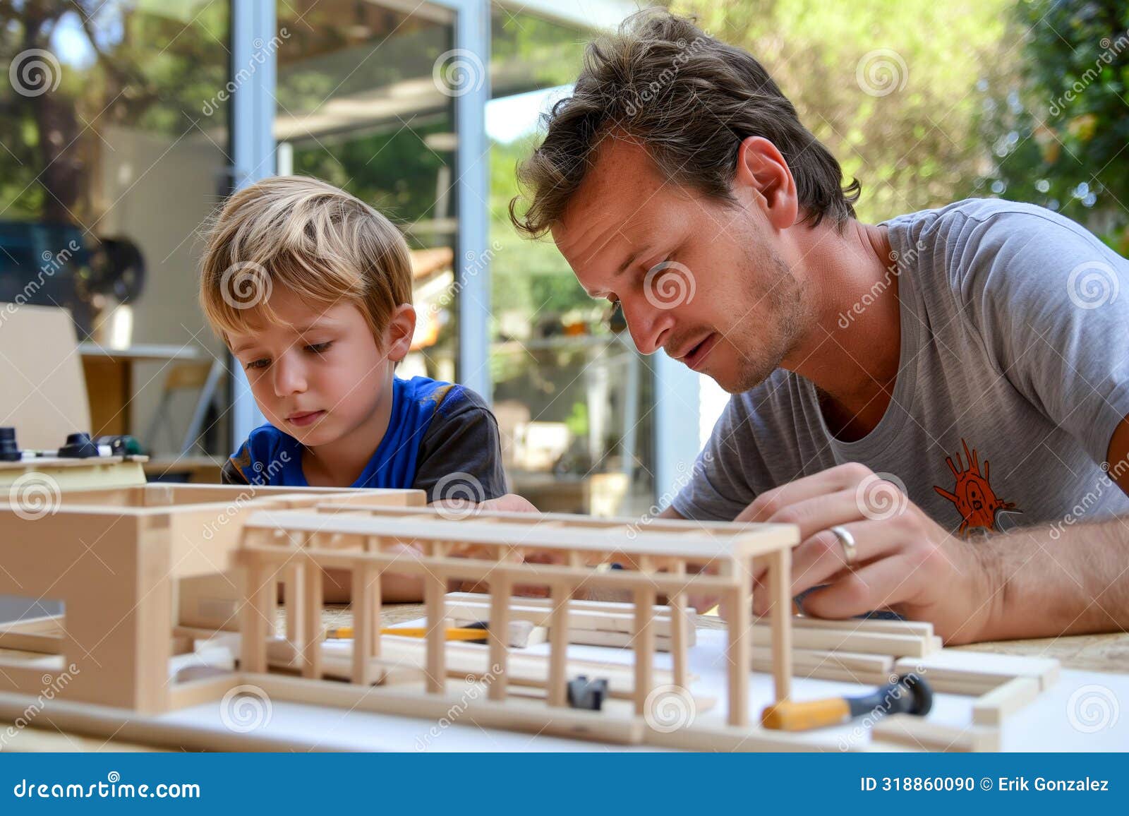 A Man and a Boy are Working on a Model of a Building Stock Illustration ...