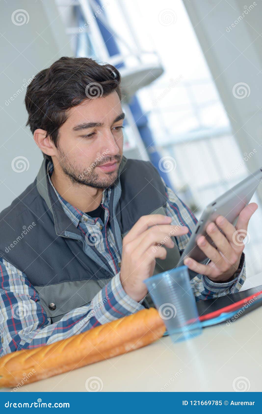 Man on break using tablet stock image. Image of active - 121669785
