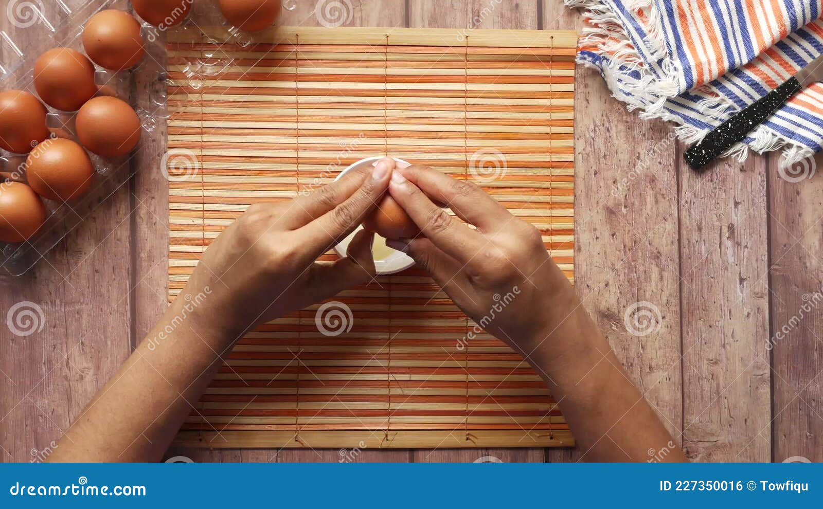 Man Breaking Egg and Pouring into a Small Container on Table , Stock ...
