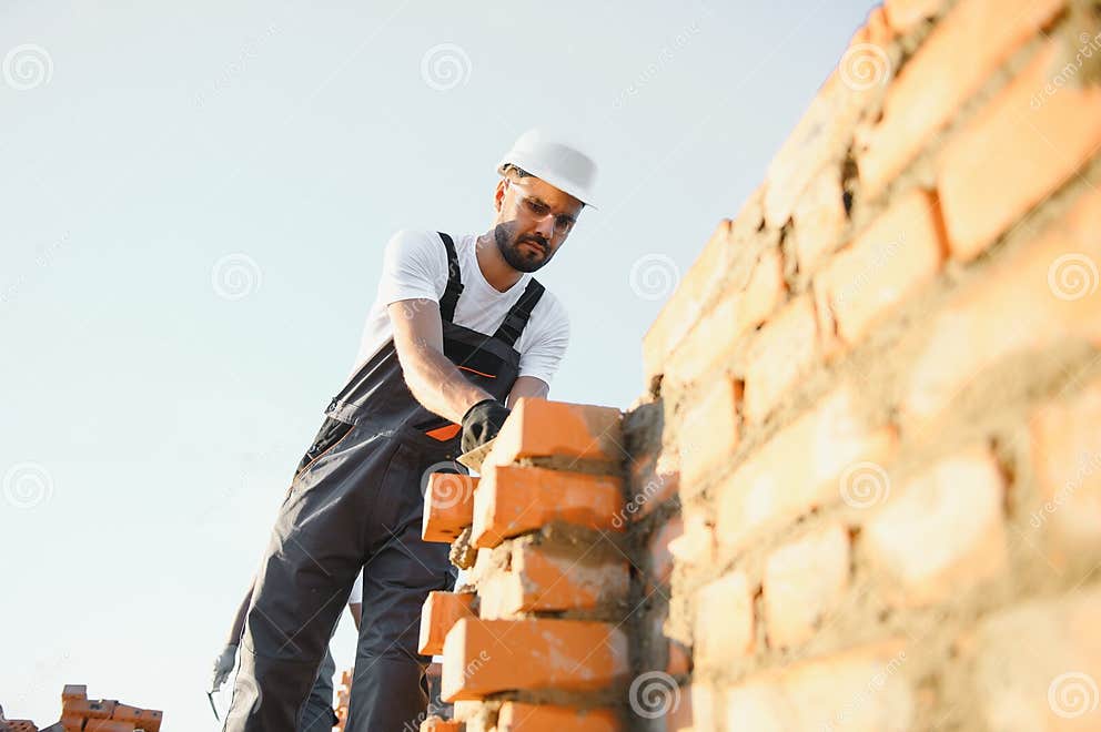 Man Bricklayer Installing Bricks on Construction Site Stock Photo ...