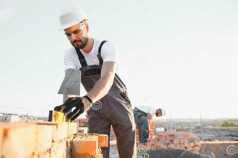 Man Bricklayer Installing Bricks on Construction Site Stock Photo ...
