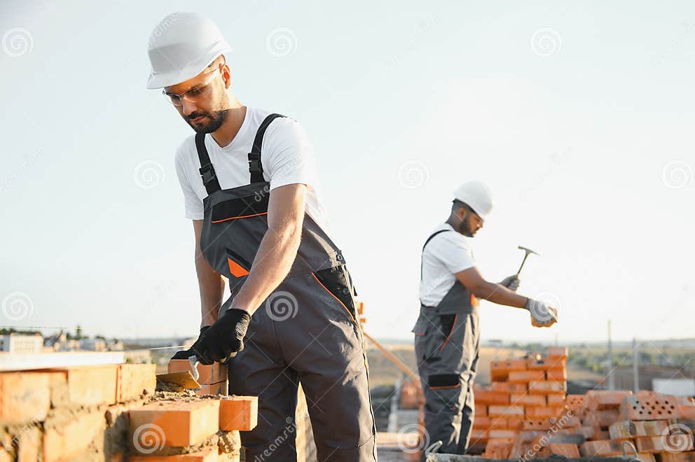 Man Bricklayer Installing Bricks on Construction Site Stock Photo ...