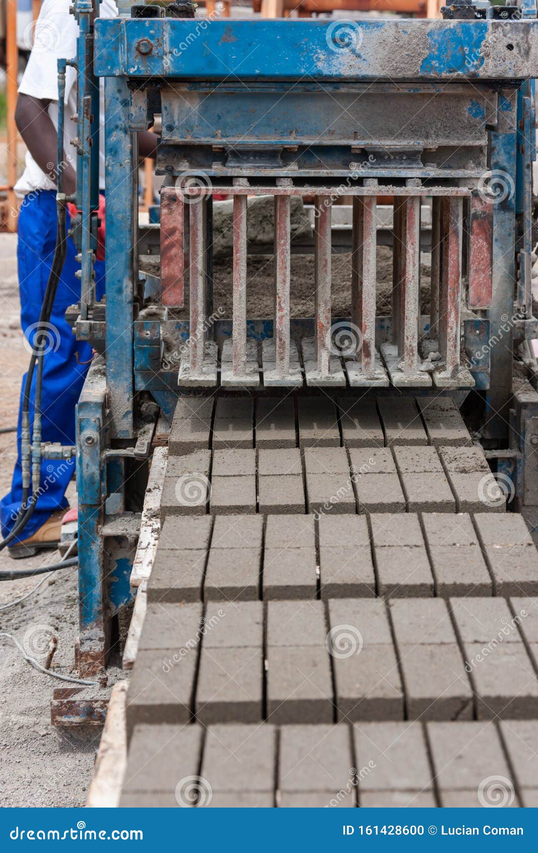 Man and bricks machine stock photo. Image of cement - 161428600