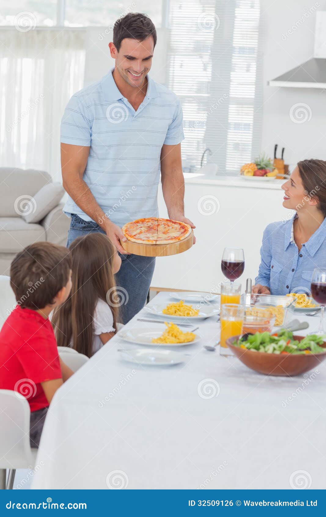 Man Bringing a Pizza To His Family Stock Photo - Image of board ...